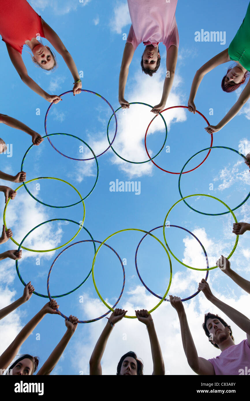 People holding hula hoops in circle Stock Photo - Alamy