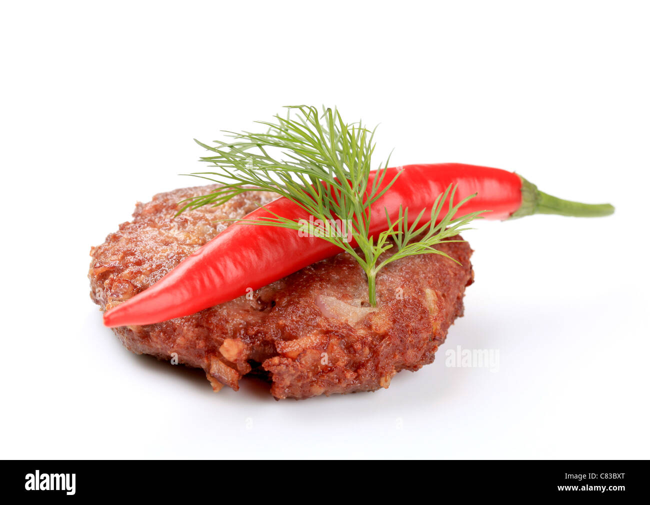 Pan fried hamburger patty and red chilli pepper Stock Photo - Alamy