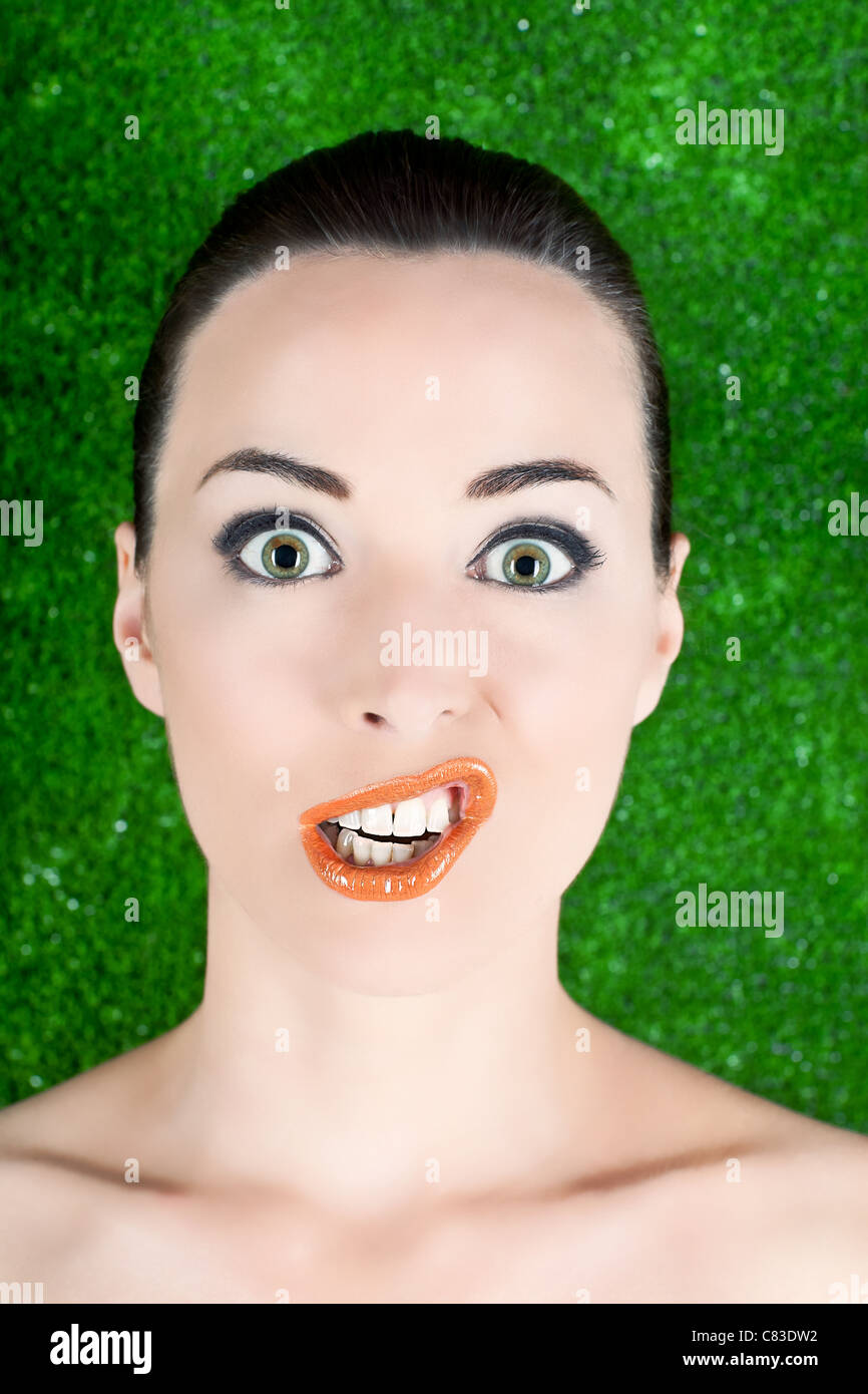Closeup portrait of a woman funny grimacing isolated on green Stock ...