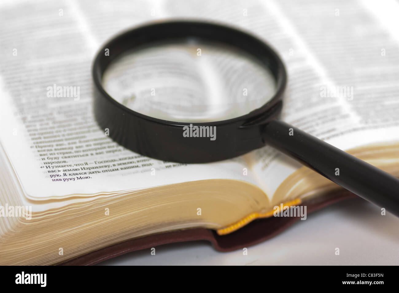Magnifying glass on book Stock Photo - Alamy