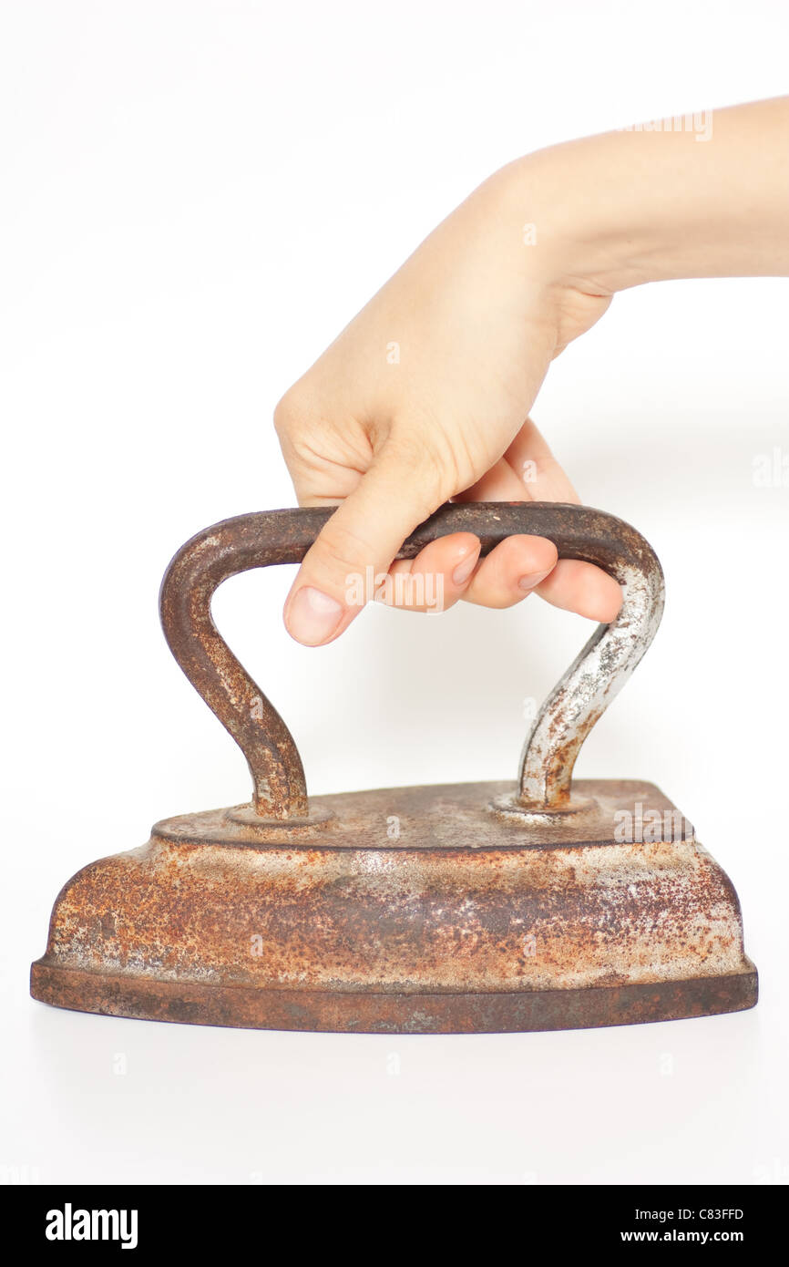 Woman hand and old iron on a white background Stock Photo - Alamy