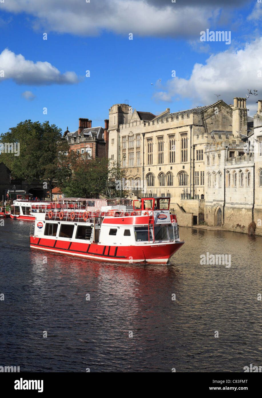 A pleasure boat takes tourists for a trip on the river Ouse, York ...