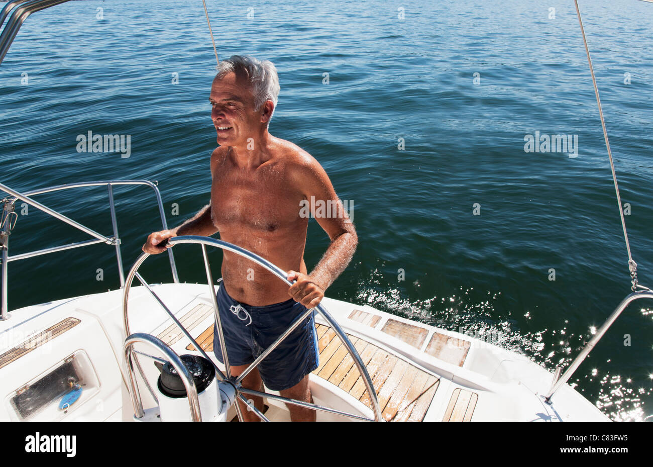Older man sailing on lake Stock Photo - Alamy