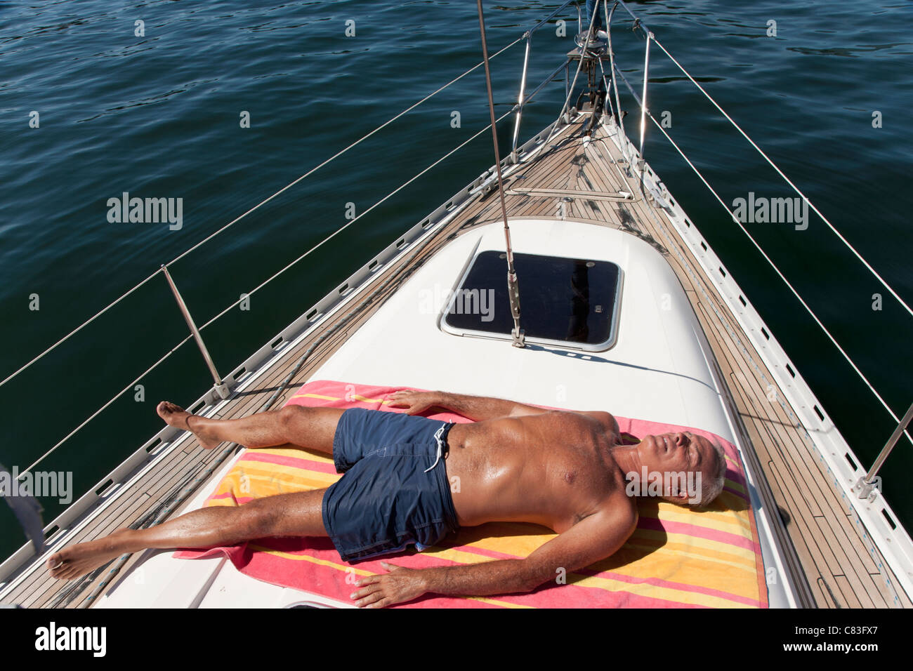 Older man relaxing on sailboat Stock Photo - Alamy