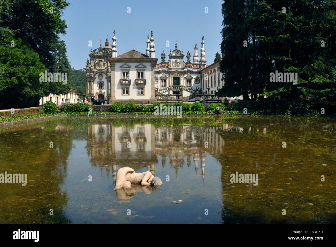 Baroque Mateus Palace behind a pond with a statue of a resting woman ...