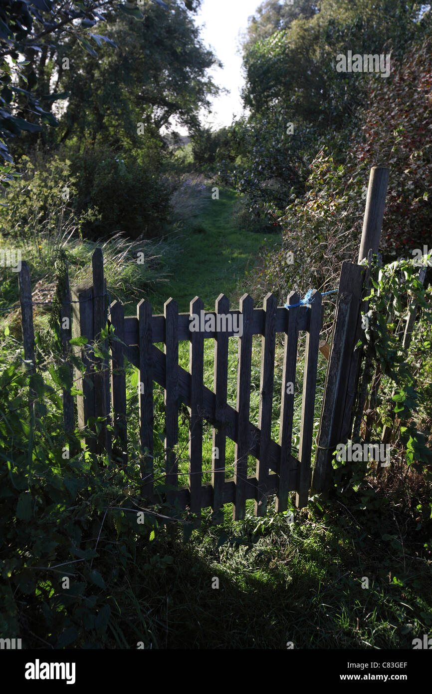 back lit garden gate, with idyllic green path leading ahead into rural ...
