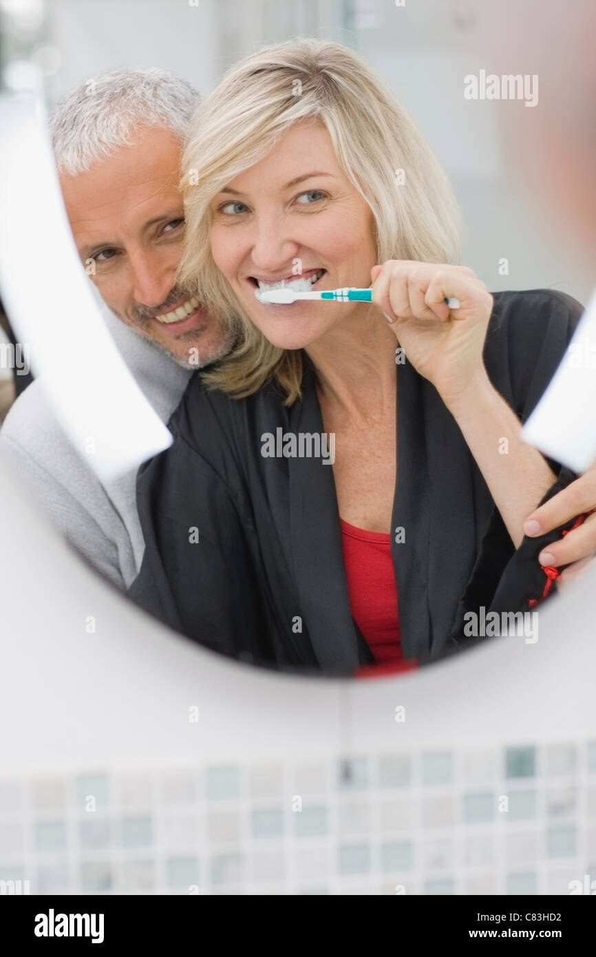 Couple hugging brushing teeth hi-res stock photography and images - Alamy