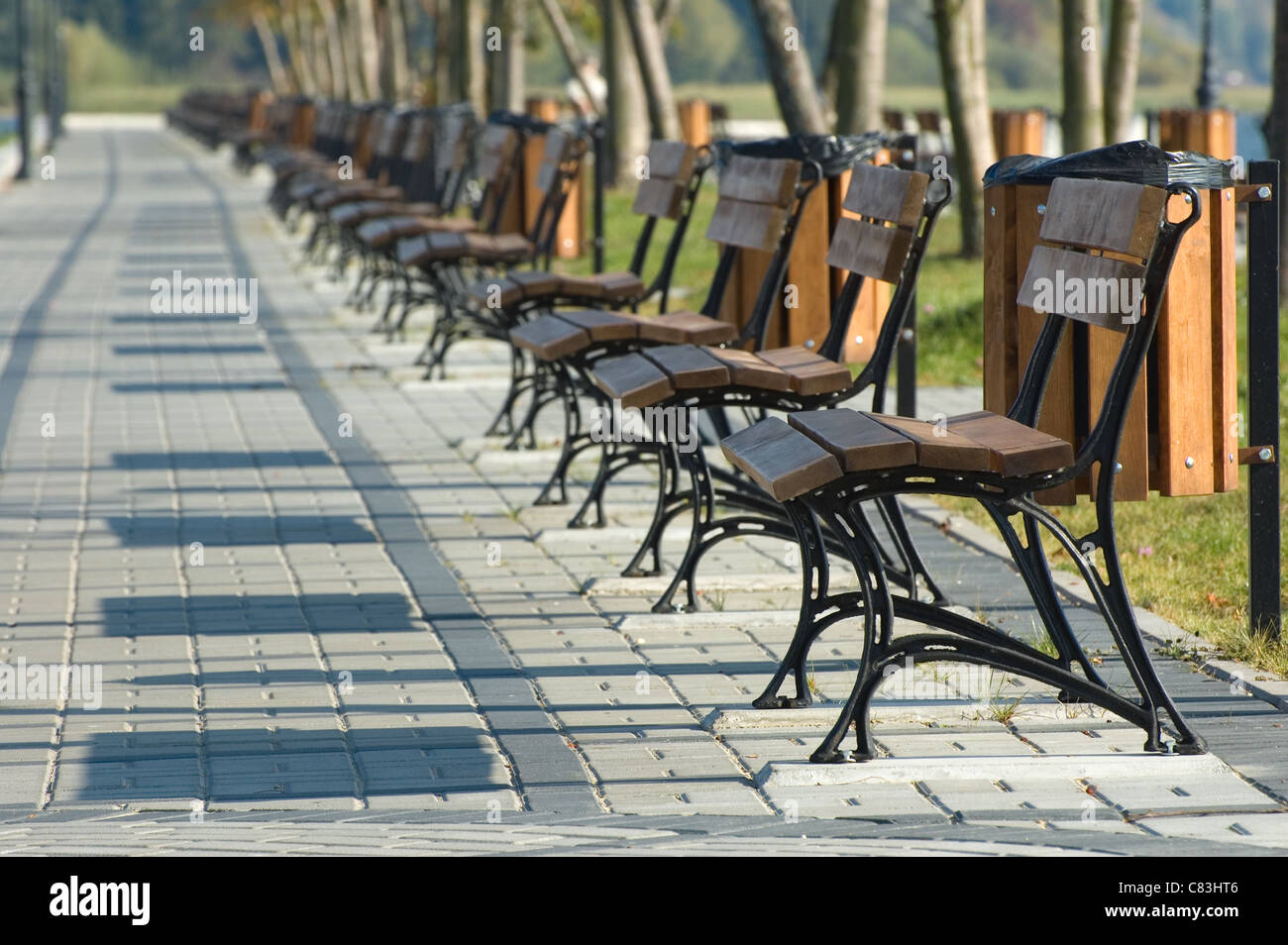 Metallic and wooden benches in a park Stock Photo - Alamy