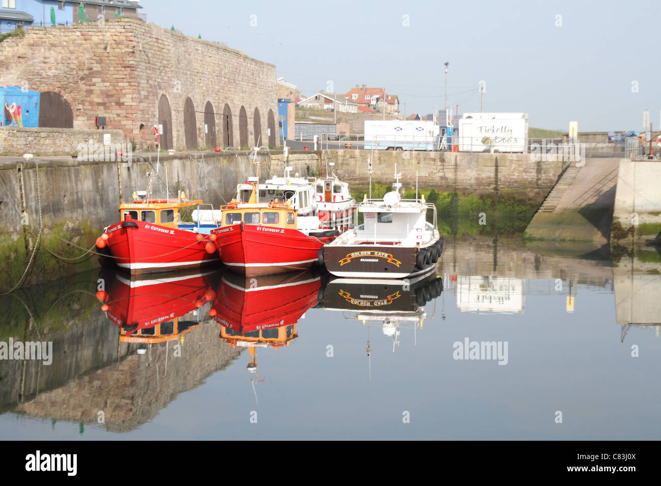 three boats seahouses harbor Stock Photo - Alamy