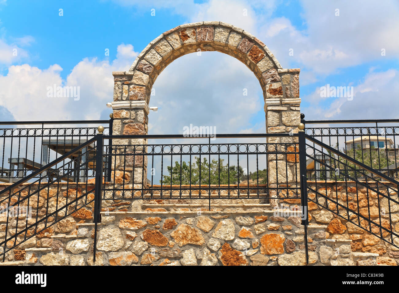 Stone textured arc in Greece against cloudy sky Stock Photo - Alamy