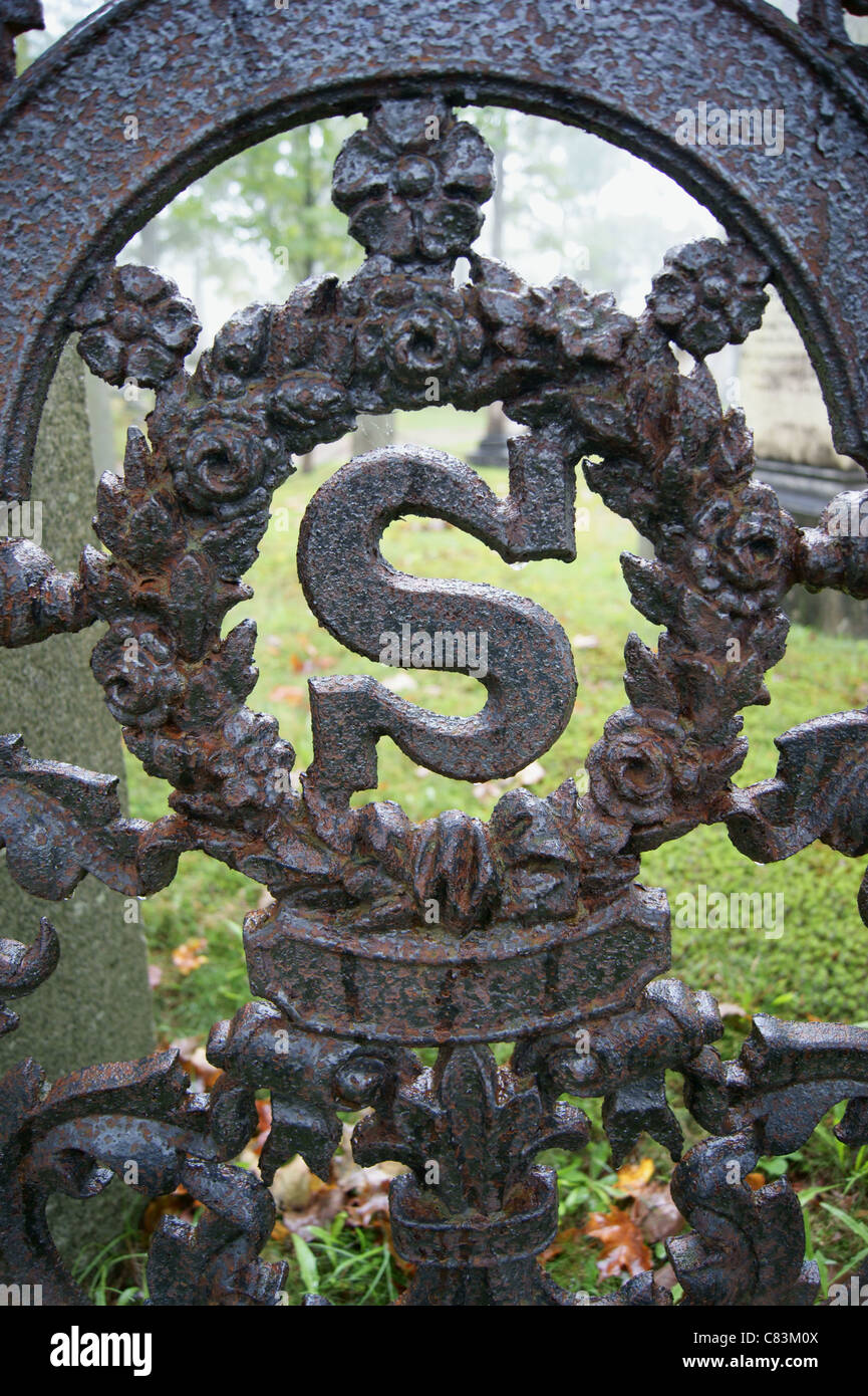 Close-up of a rusty wrought iron gate to a cemetery plot with the ...