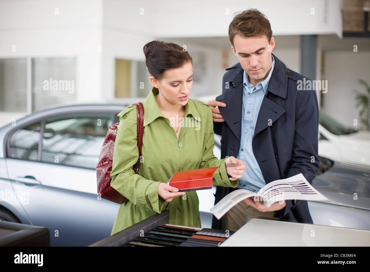 Couple picking out swatches in showroom Stock Photo - Alamy