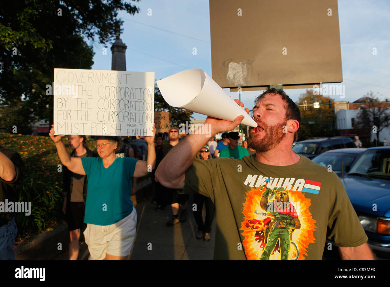 man shouting slogans Protesters march during Occupy Bloomington ...