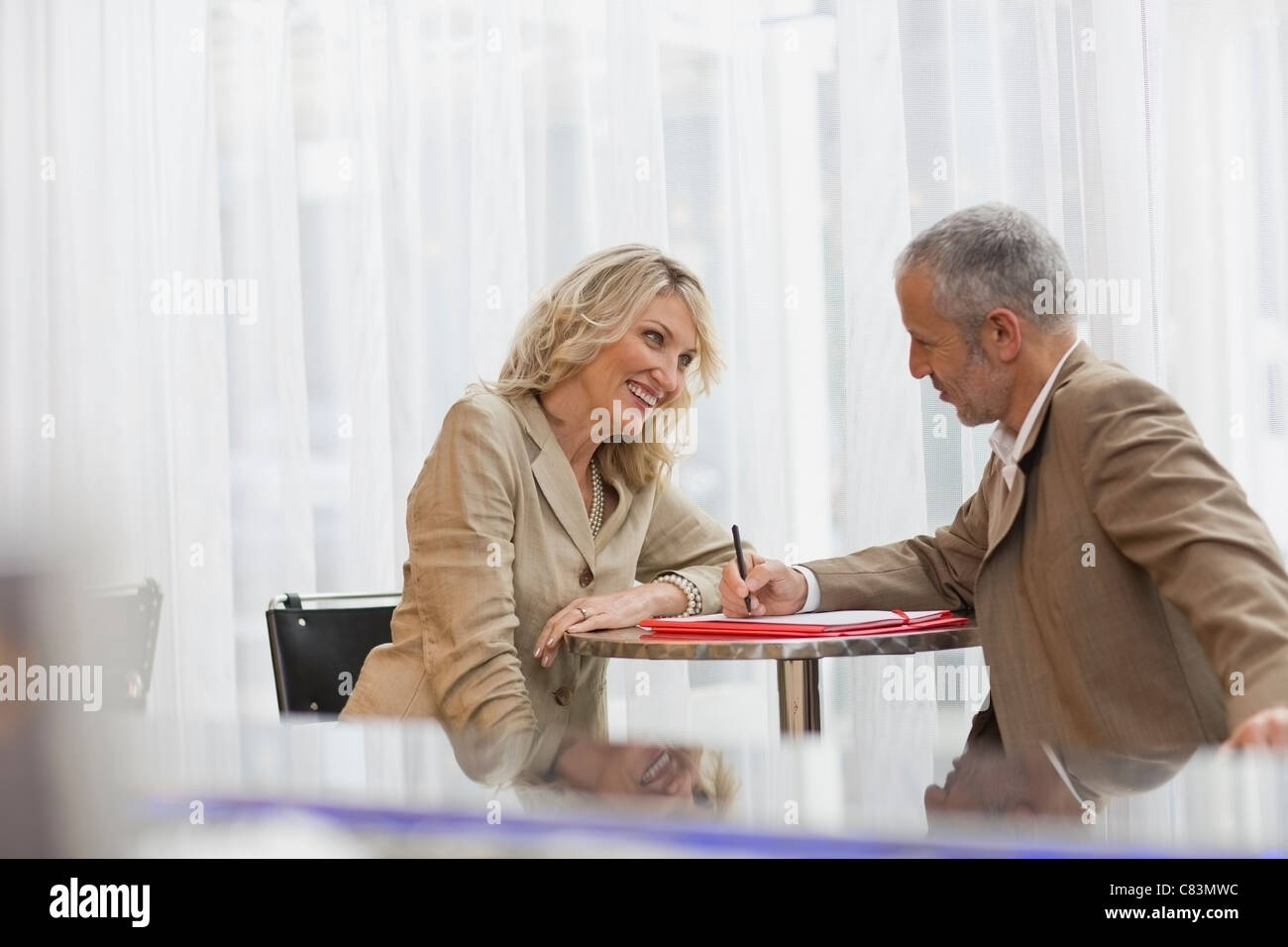 Business people talking in lobby area Stock Photo - Alamy