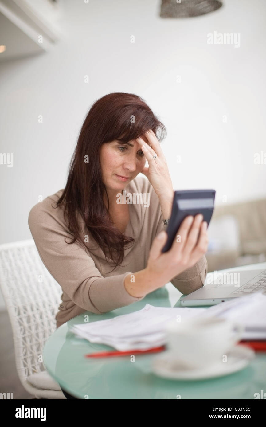 Woman paying her bills at home Stock Photo - Alamy