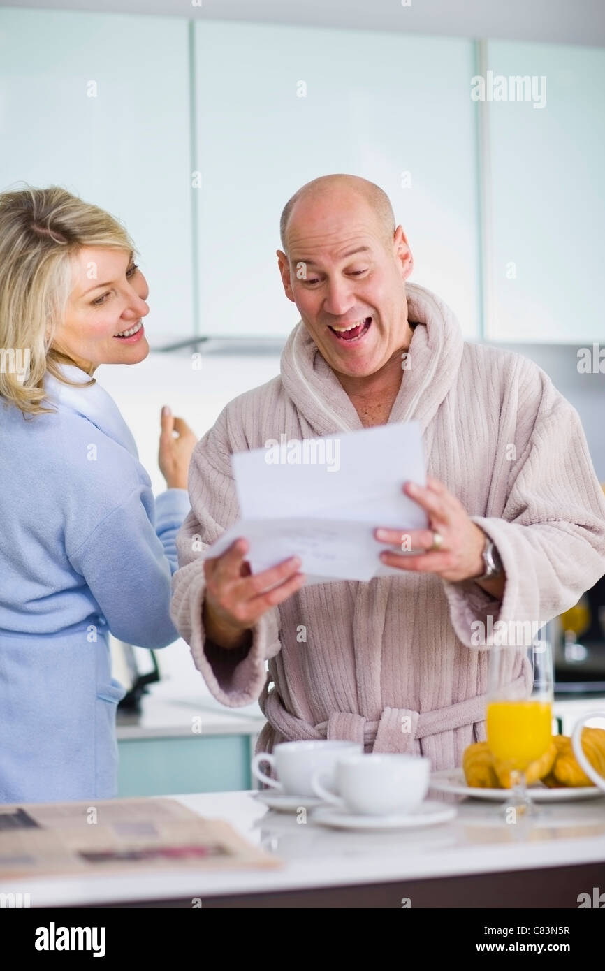 Surprised man reading mail Stock Photo - Alamy