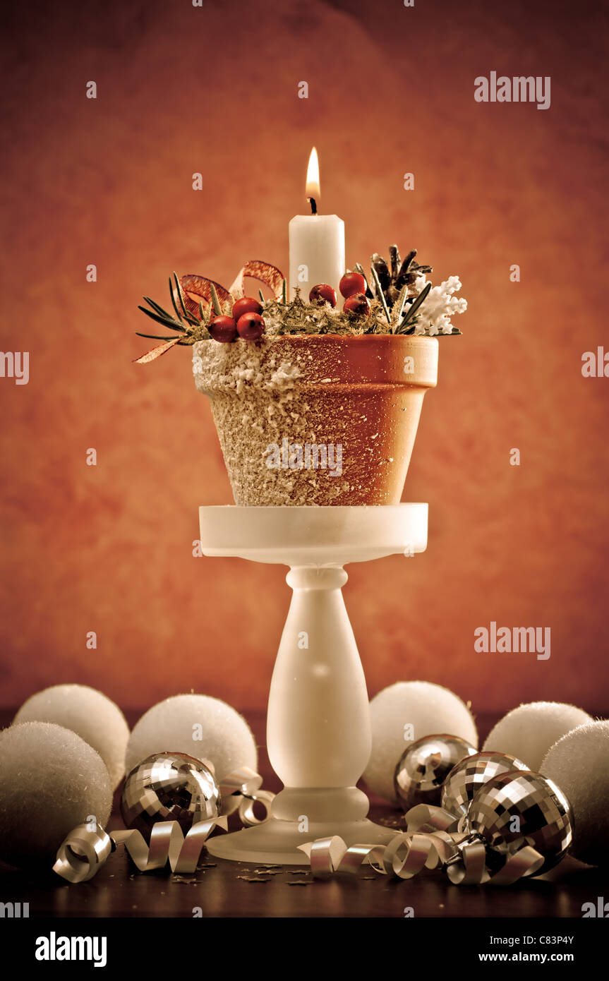 Single lit Christmas candle and baubles with festive background Stock ...