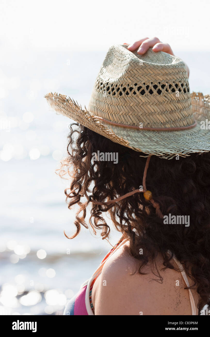 Woman wearing sunhat on beach Stock Photo - Alamy