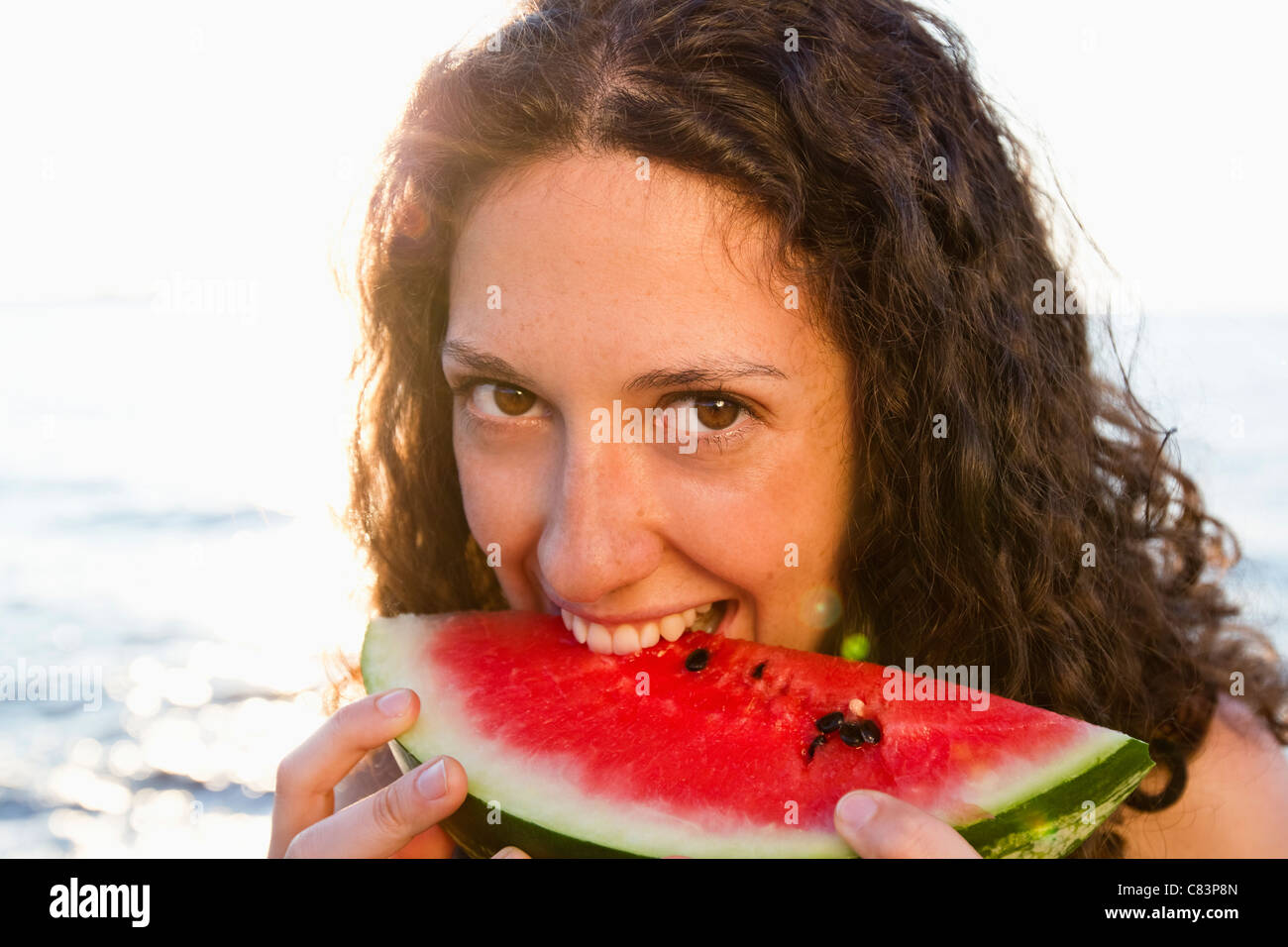 Smiling woman eating watermelon Stock Photo - Alamy