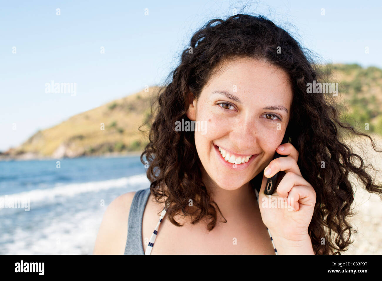 Woman talking on cell phone on beach Stock Photo - Alamy