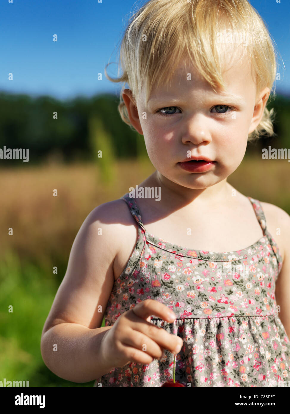 Toddler girl standing outdoors Stock Photo - Alamy