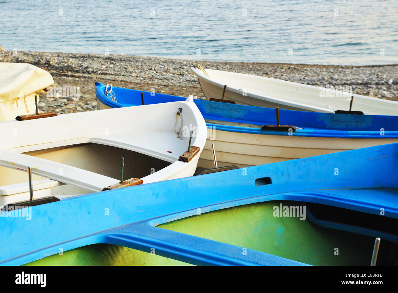 Empty canoes on rocky beach Stock Photo - Alamy