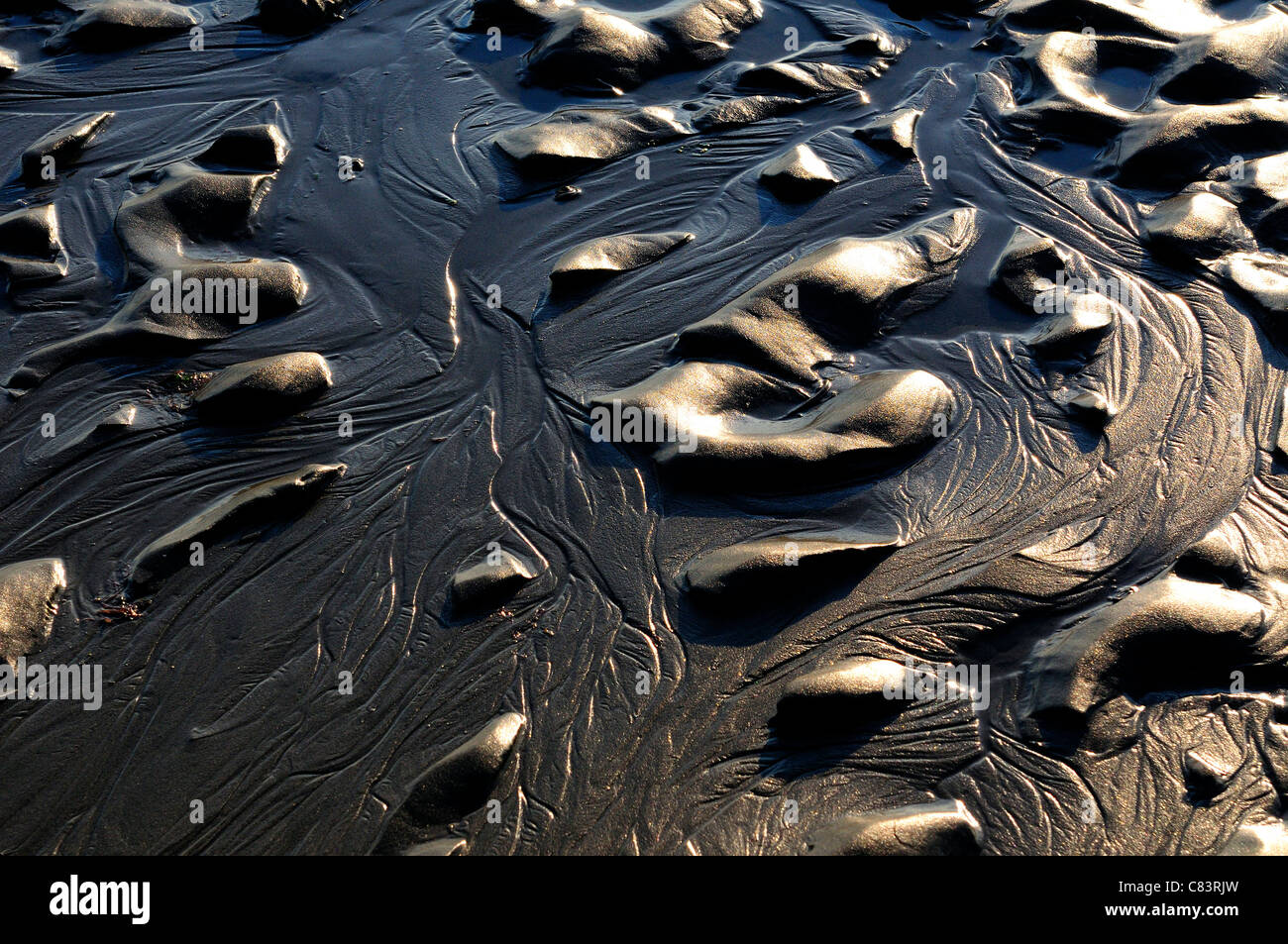 Patterns in the sand from the water receding at low tide on West ...