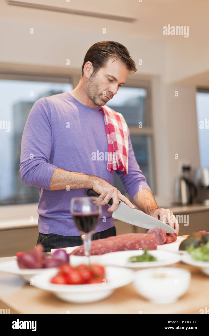 Man cooking dinner in kitchen Stock Photo - Alamy