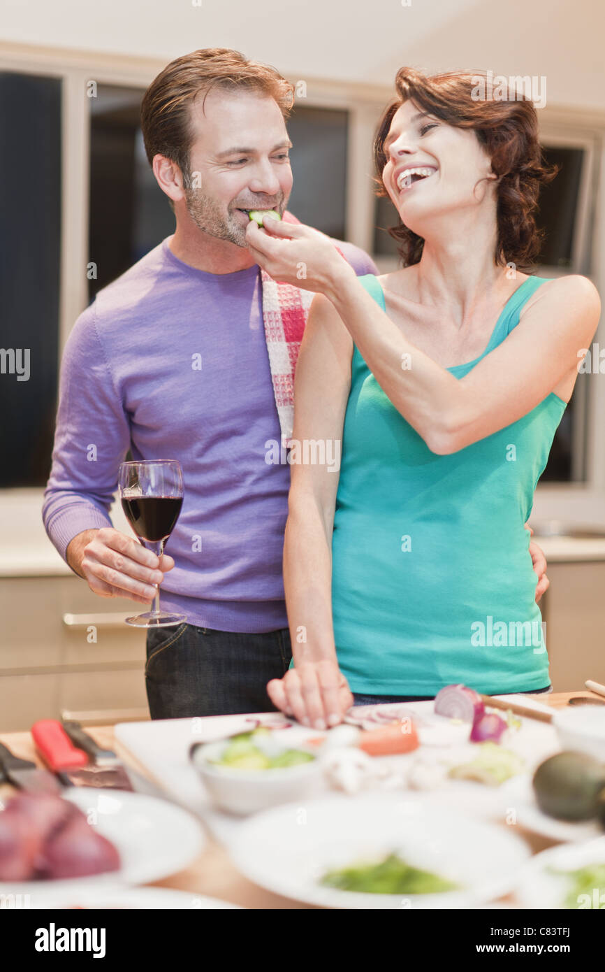 Couple eating and cooking dinner Stock Photo - Alamy