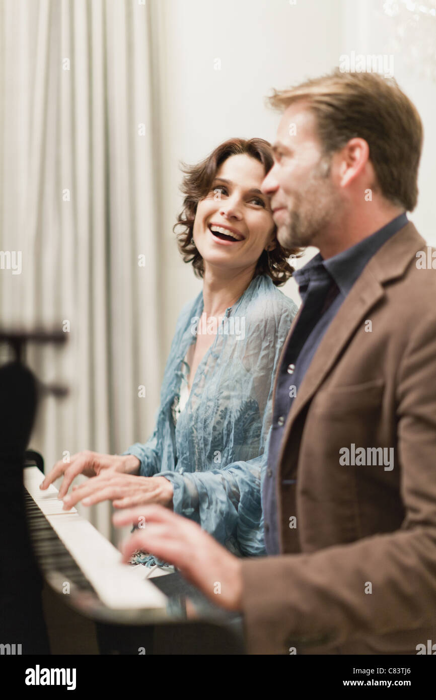Couple playing piano together at home Stock Photo - Alamy