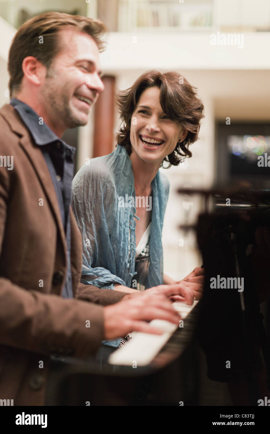 Couple playing piano together at home Stock Photo - Alamy