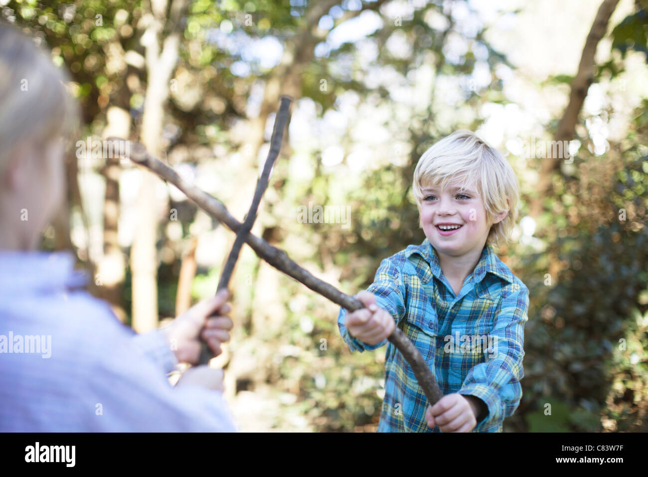 Mother and son playing with sticks Stock Photo - Alamy