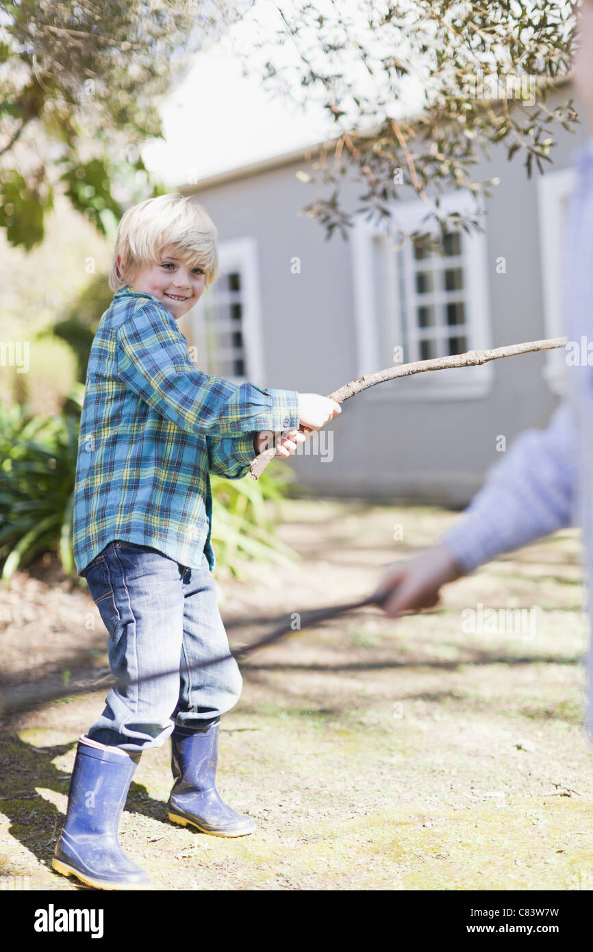 Children playing with sticks outdoors Stock Photo - Alamy