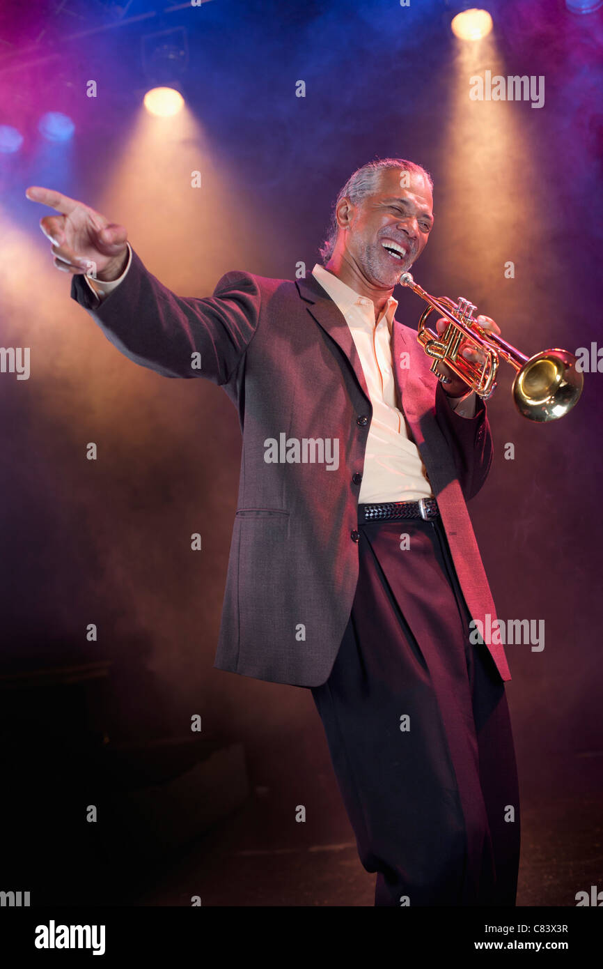 Musician playing trumpet on stage Stock Photo - Alamy