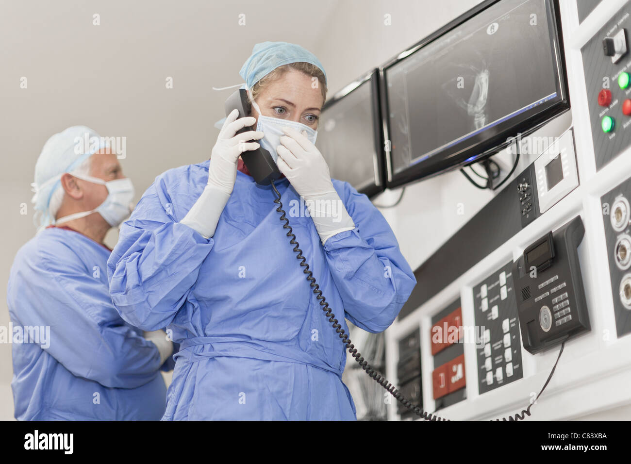 Doctor on phone in operating room Stock Photo - Alamy