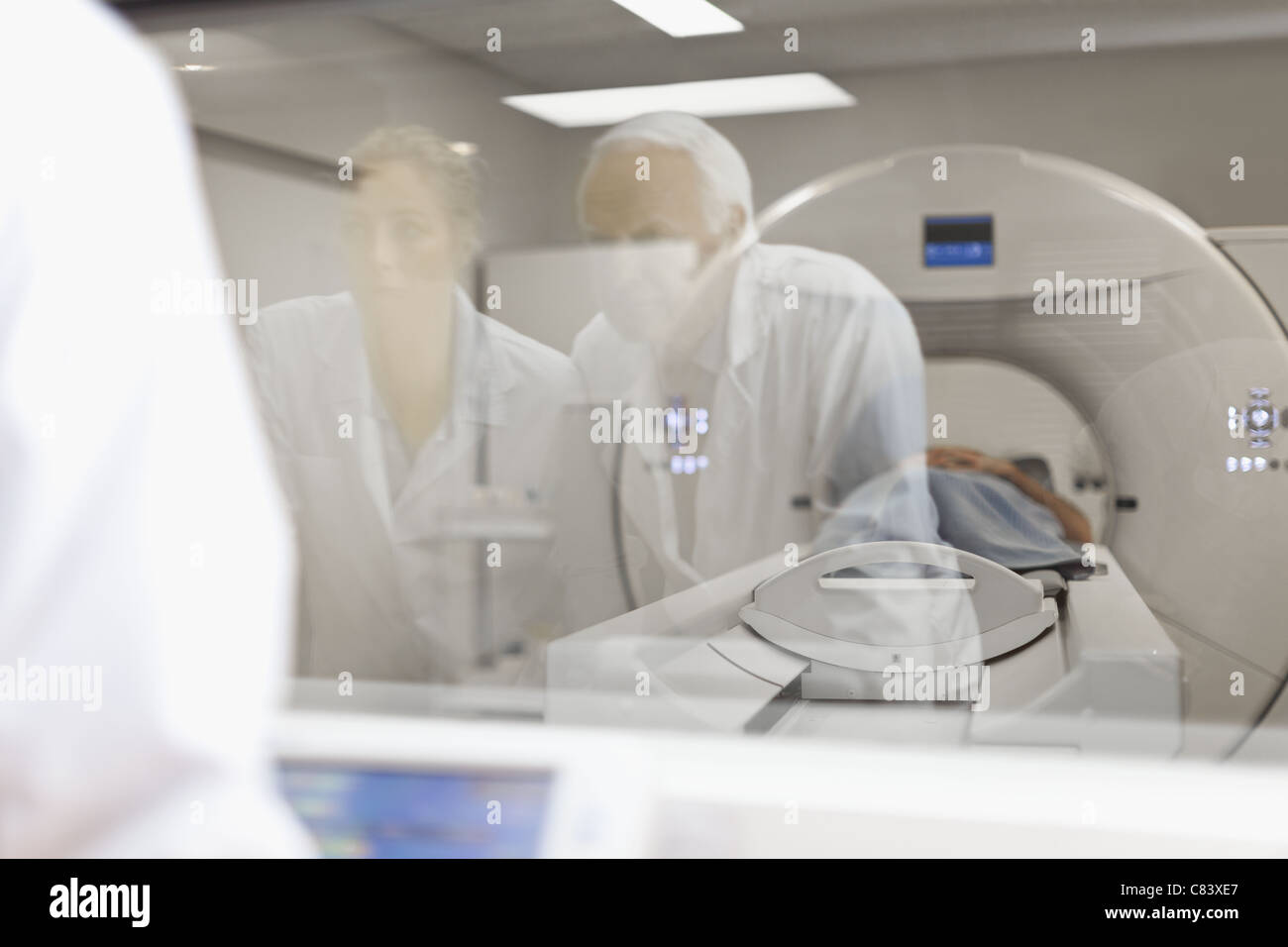 Doctors operating CT scanner in hospital Stock Photo - Alamy