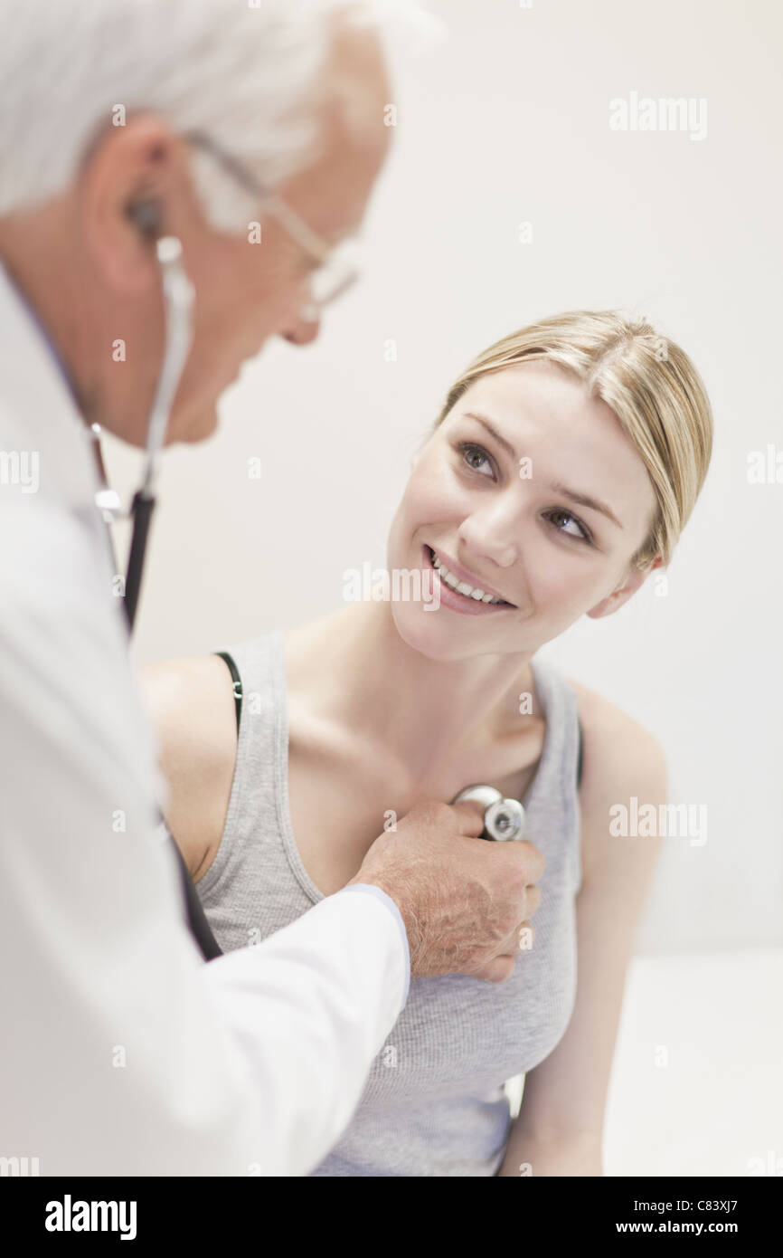 Doctor listening to patient’s heartbeat Stock Photo - Alamy