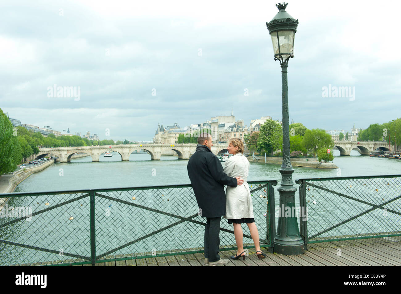 Caucasian couple talking on bridge Stock Photo - Alamy