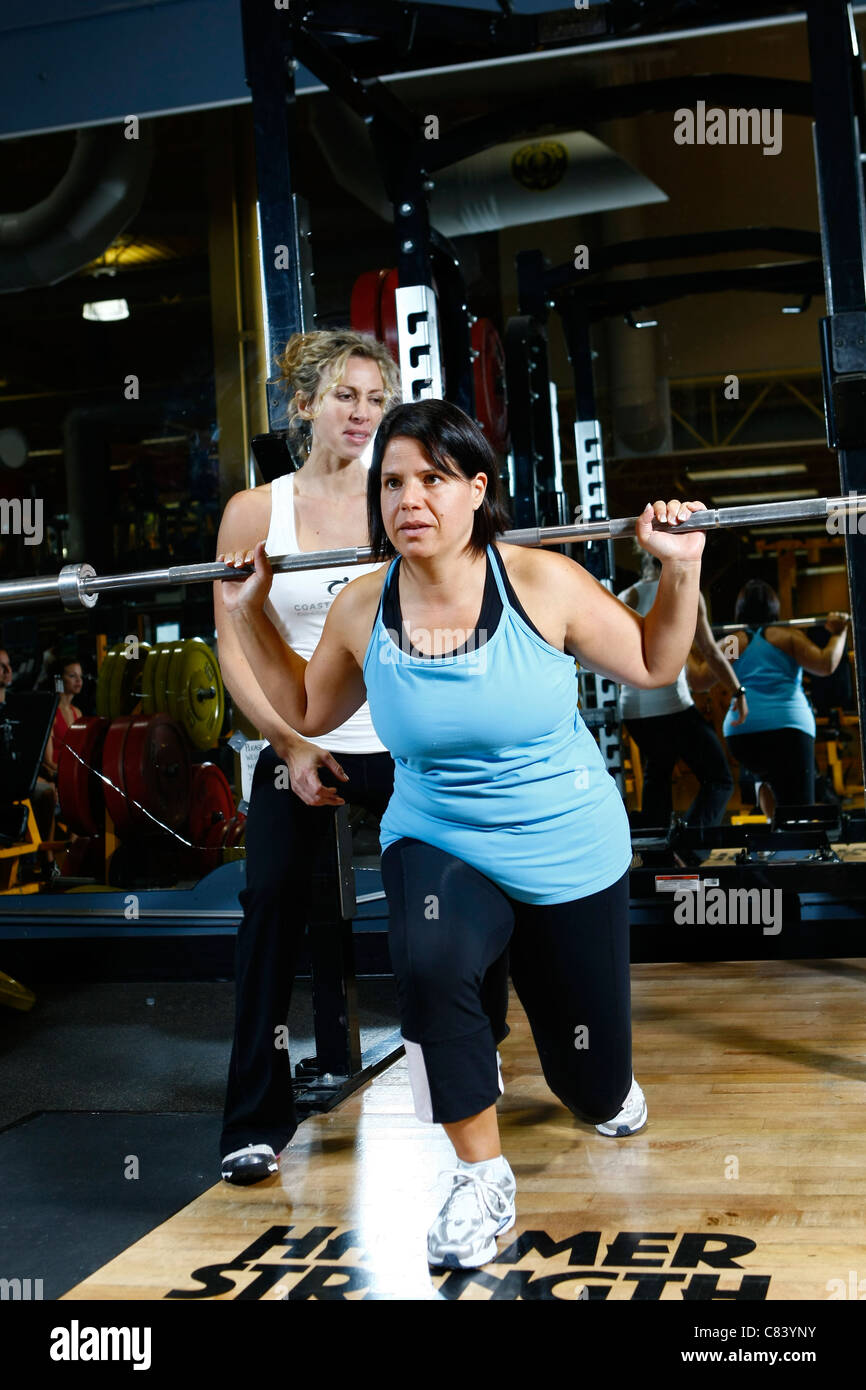 fitness personal trainer training a client in a gym Stock Photo - Alamy
