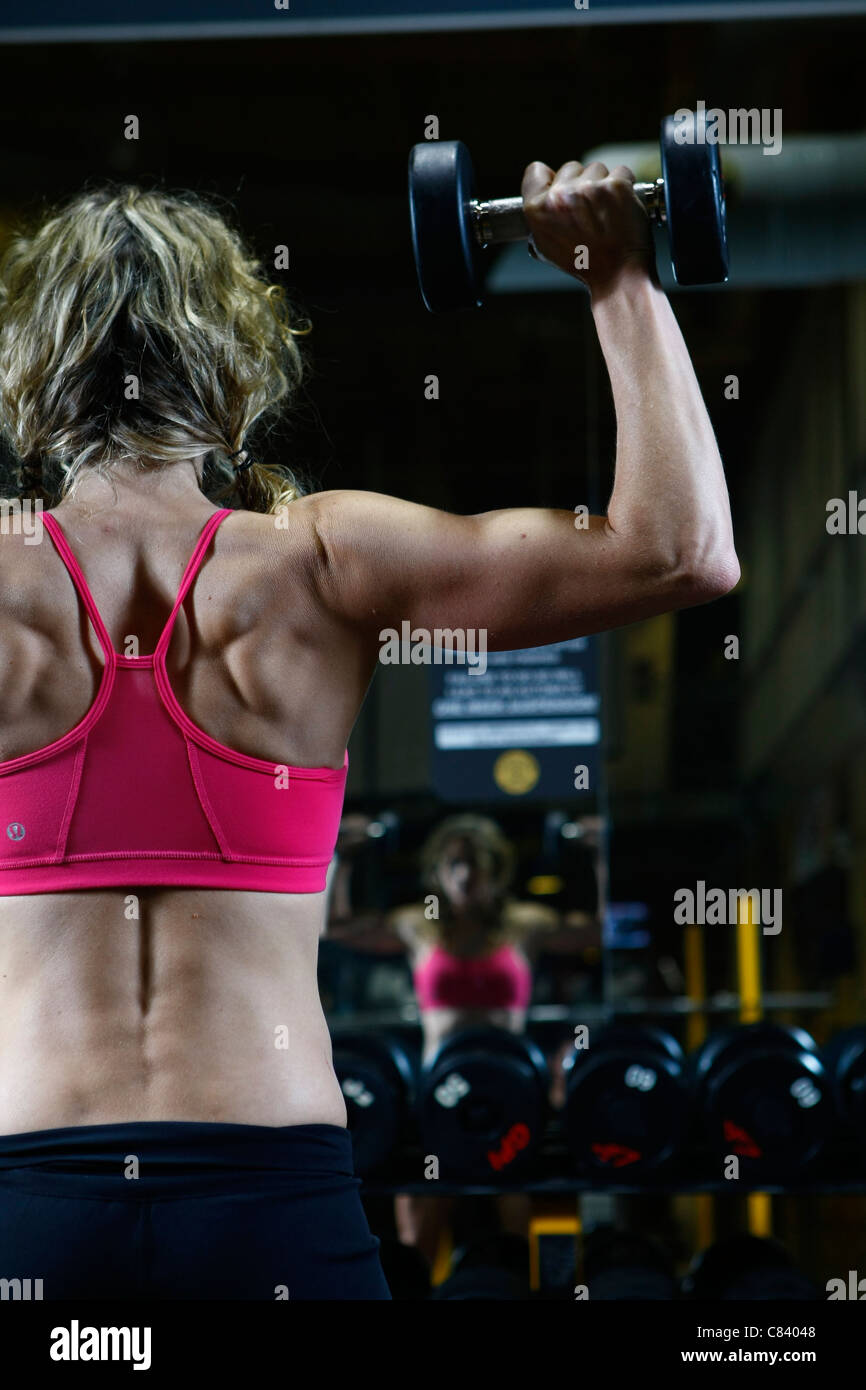 Fit female exercising in a gym Stock Photo - Alamy