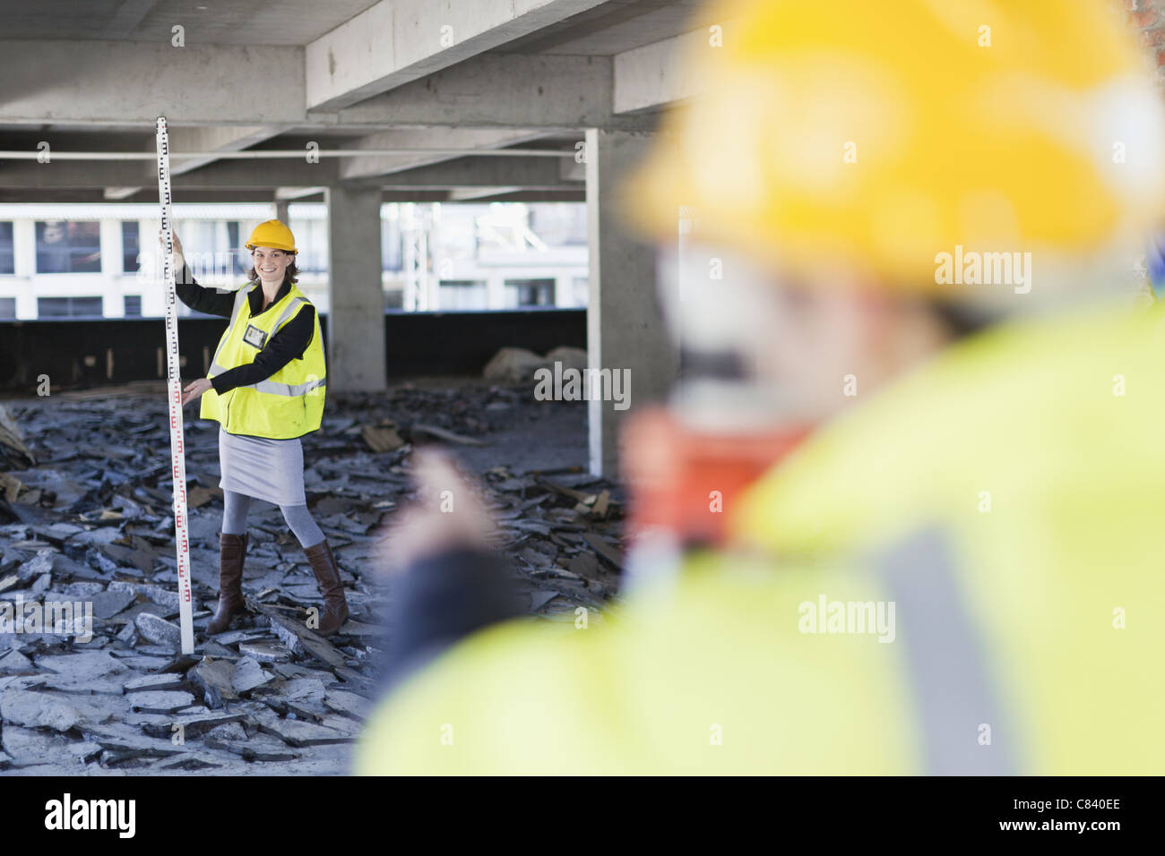 Worker measuring space on site Stock Photo - Alamy