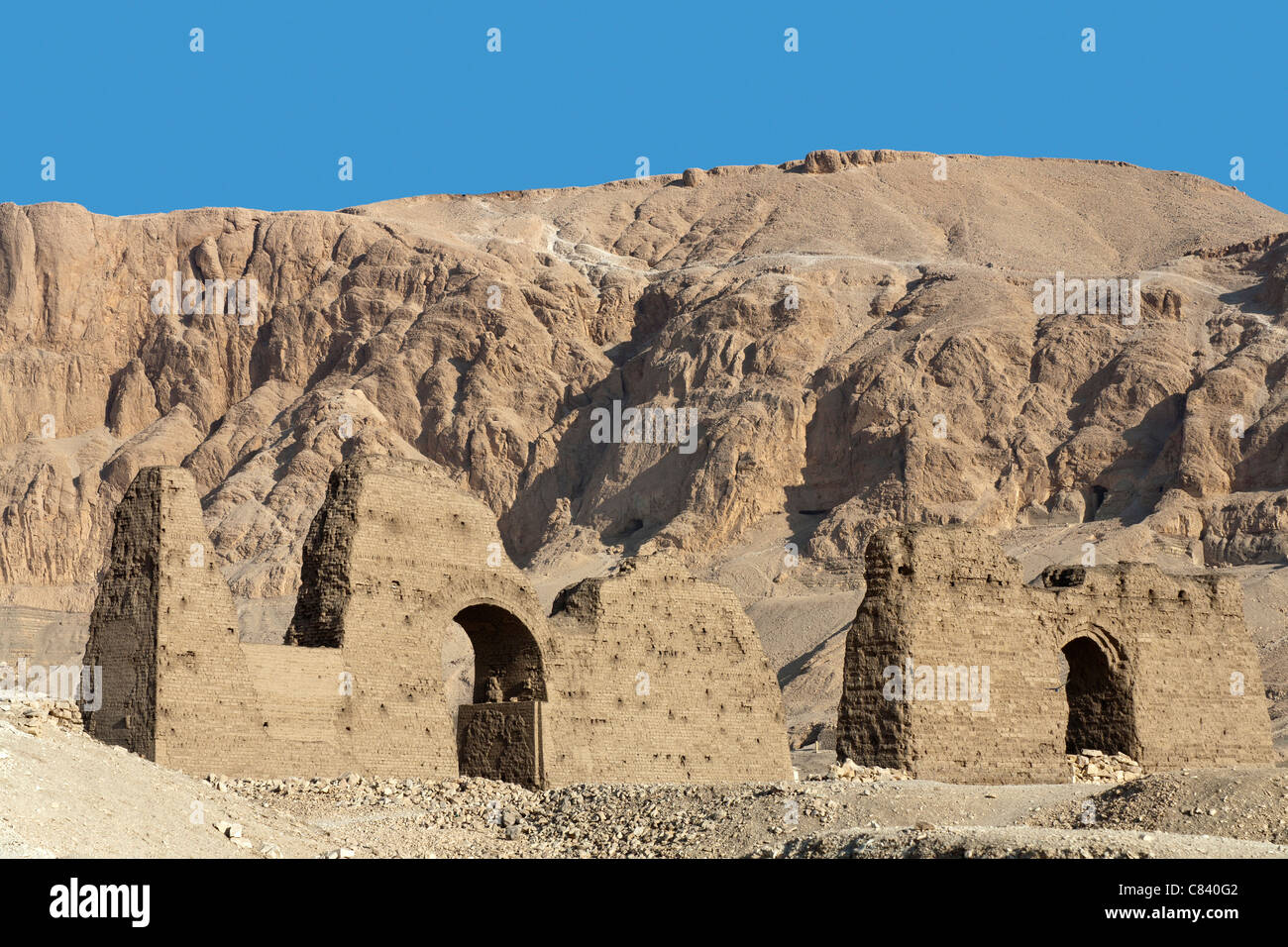 View of the the mud brick walls of the Asasif Tombs with the mountain ...