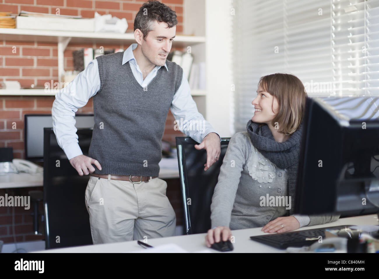 Business people talking at desk Stock Photo - Alamy