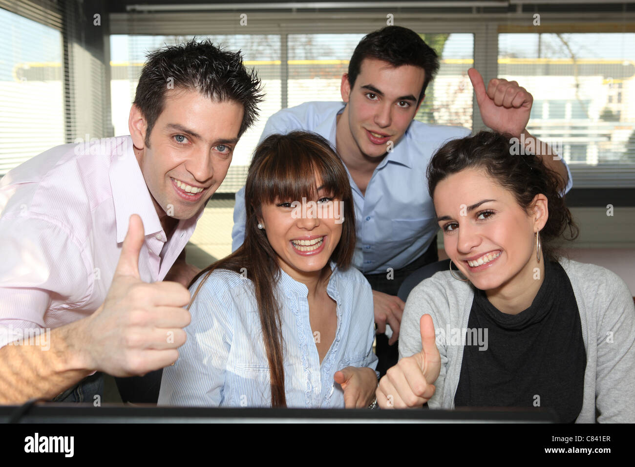 Office workers giving a thumbs up Stock Photo - Alamy