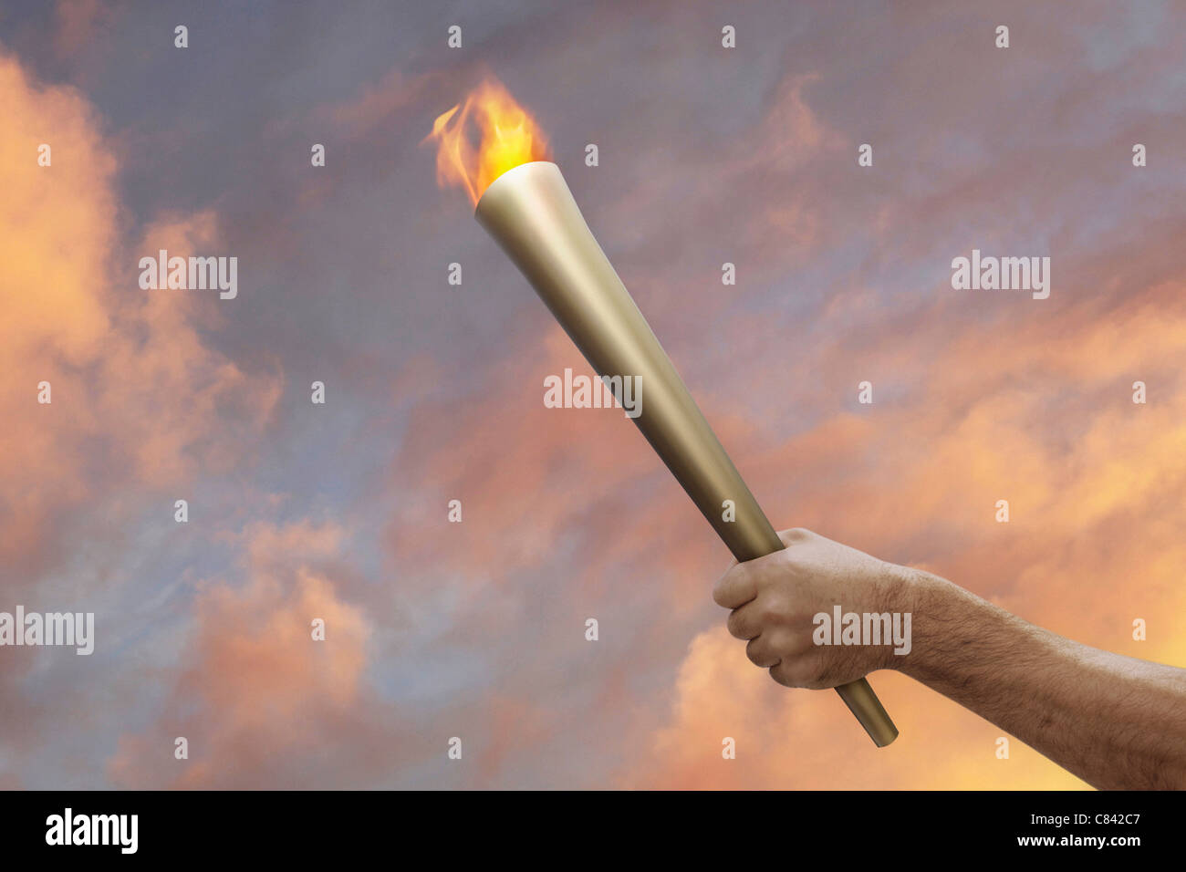 Hand holding flaming baton Stock Photo - Alamy