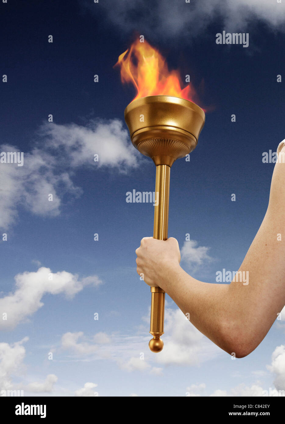 Hand holding flaming baton Stock Photo - Alamy
