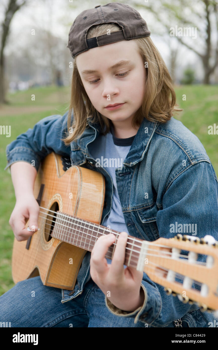 Caucasian boy playing acoustic guitar Stock Photo - Alamy