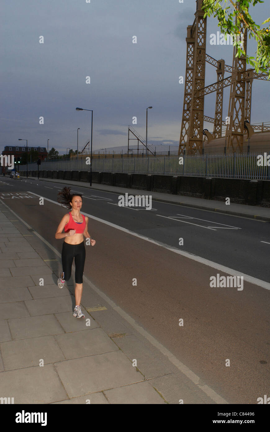 Runner jogging on city street Stock Photo - Alamy