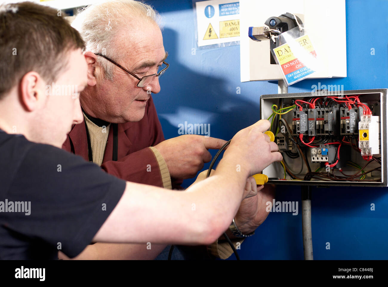 Electrical engineers working in shop Stock Photo - Alamy