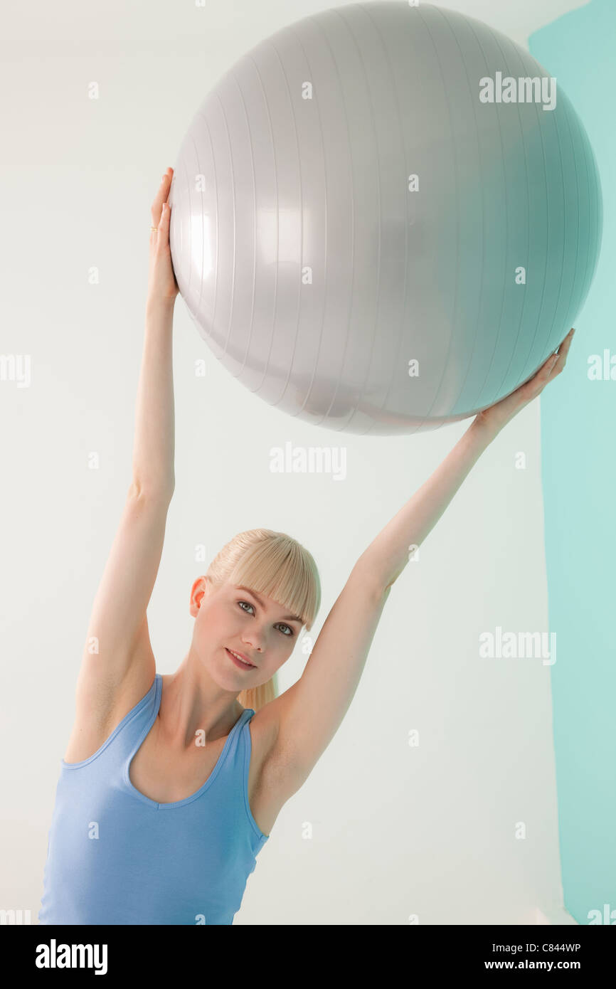 Woman holding exercise ball Stock Photo - Alamy